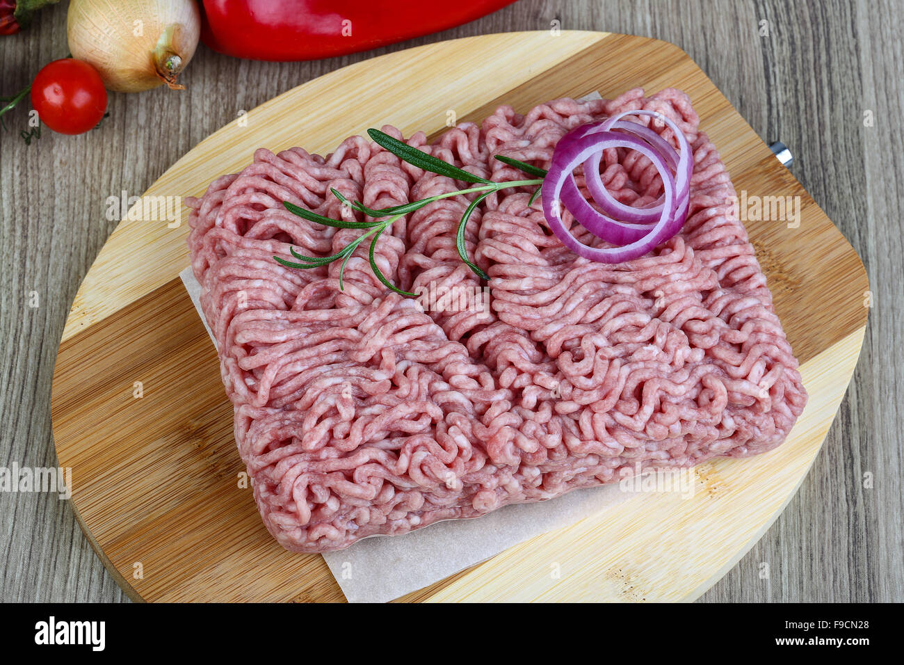 Raw minced pork meat with onion and rosemary ready for cooking Stock ...