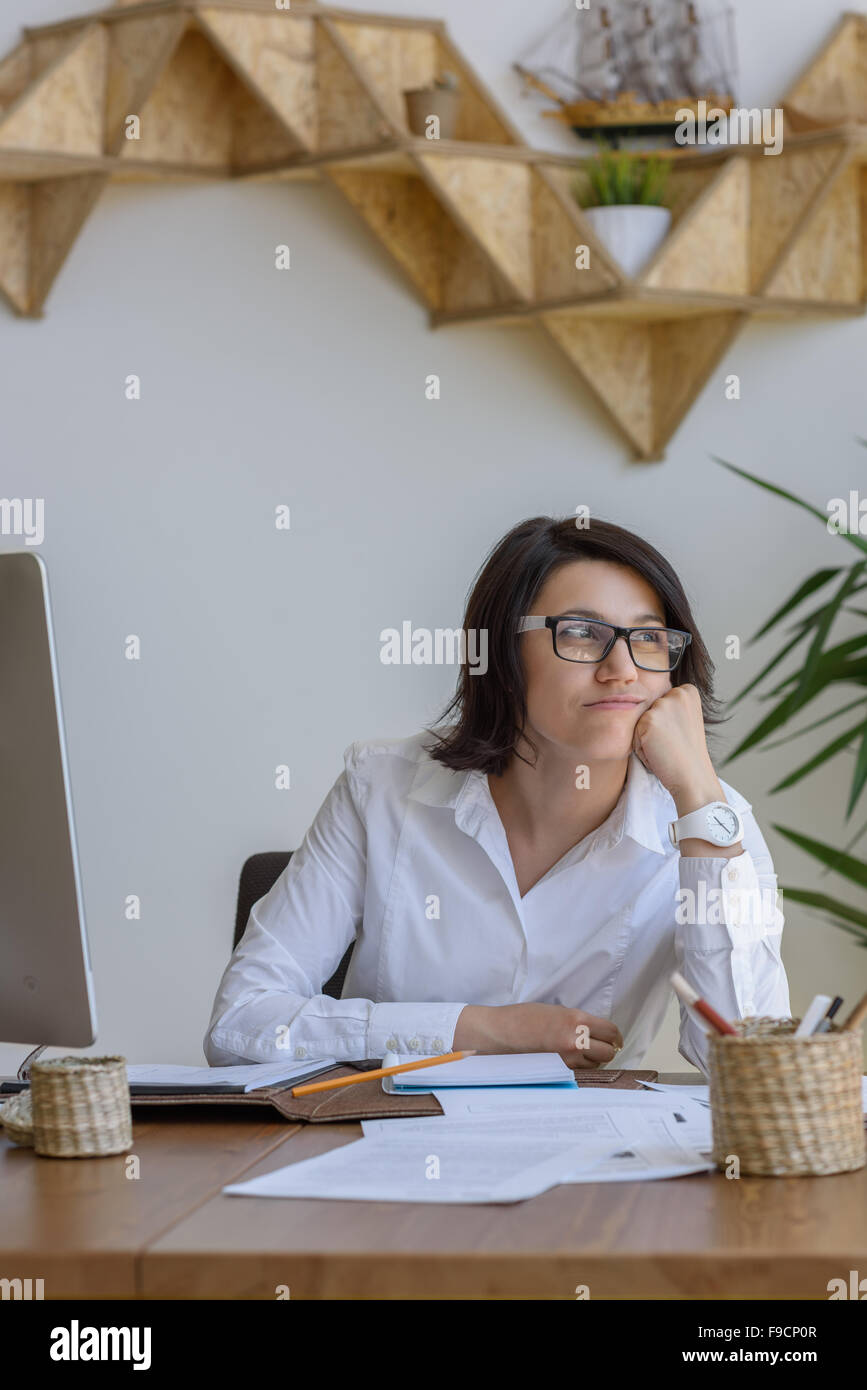 Woman thinking at her workplace Stock Photo - Alamy