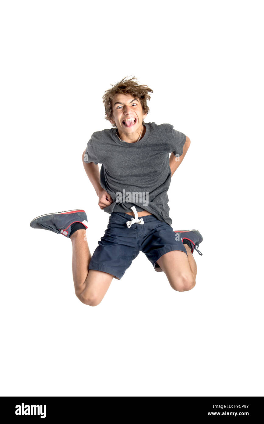 Teenage boy doing funny acrobatic jumps isolated in white Stock Photo ...