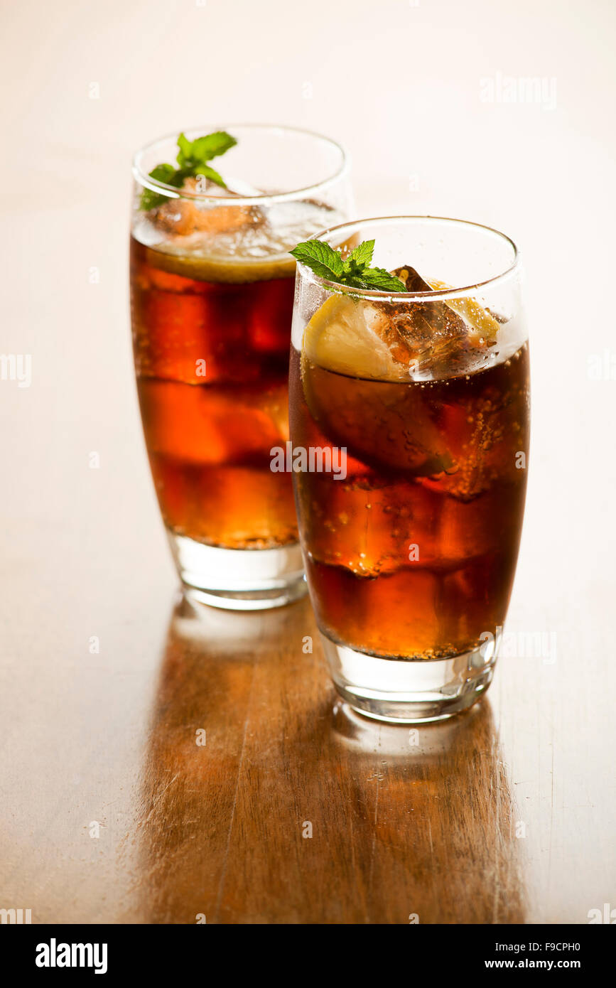 Two Glasses of fresh cola or soda drink with ice cubes and lemon Stock ...