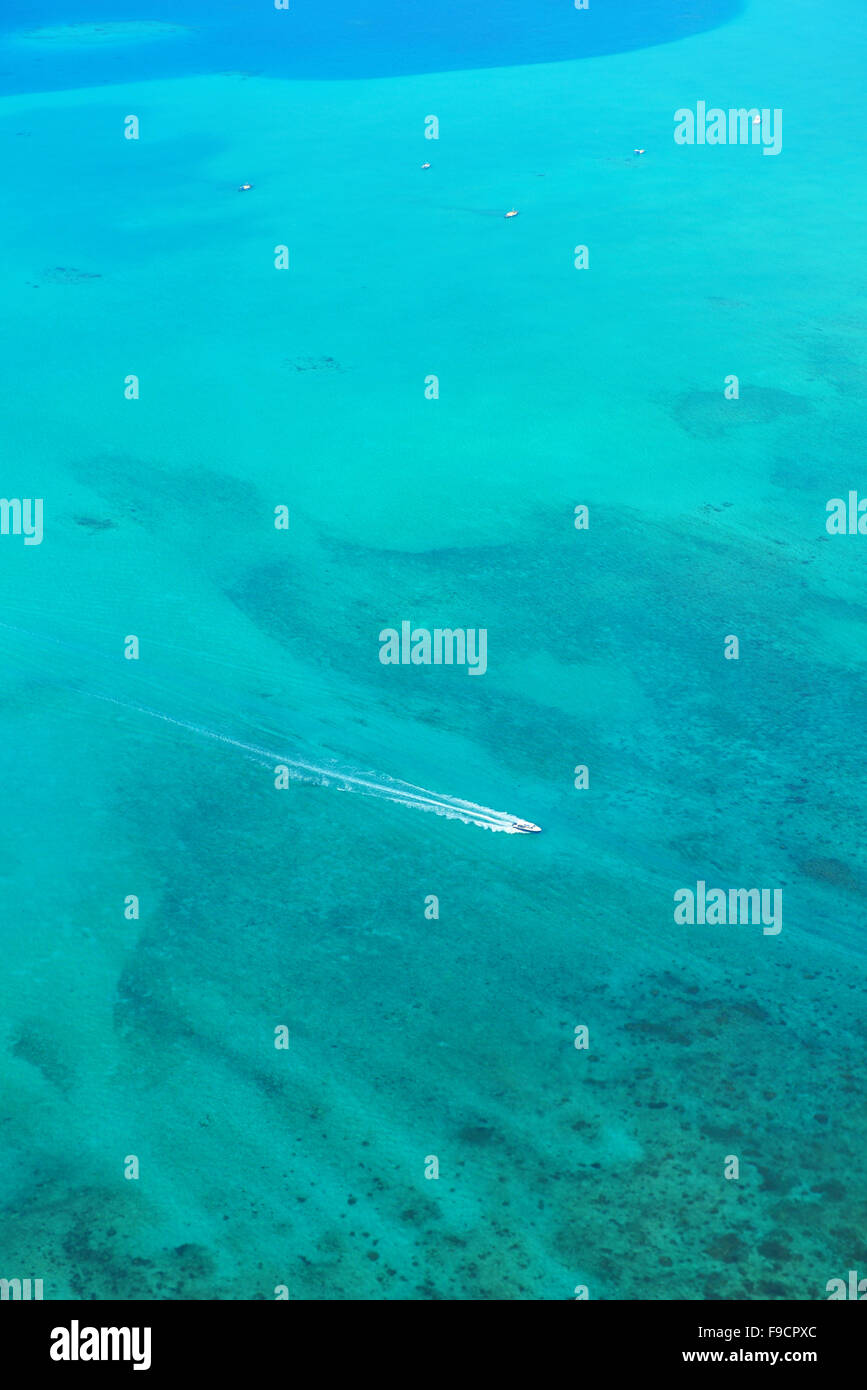 fast motor speed boat travel with splash and wake on blue tropical sea ...