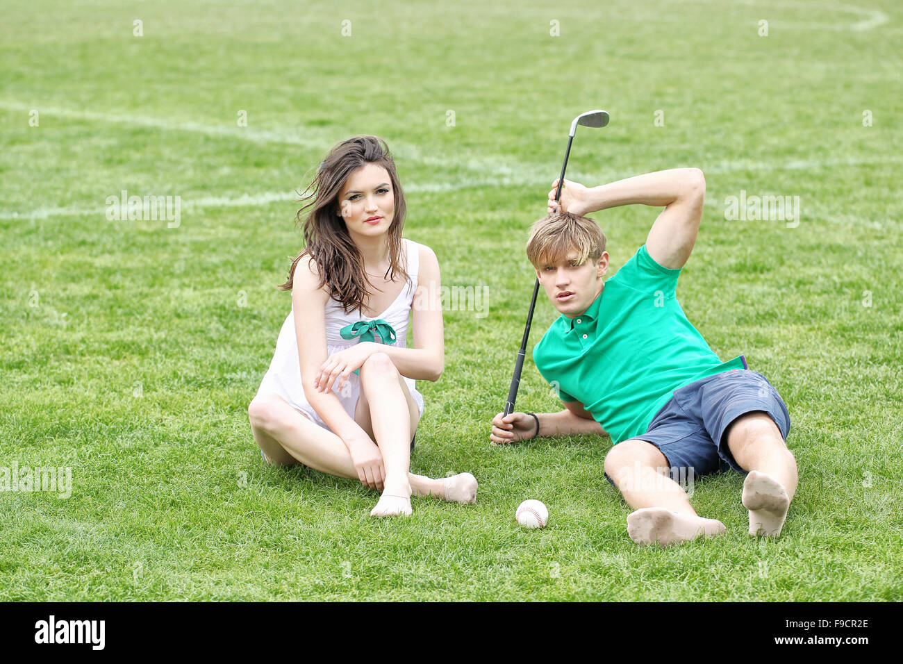 teenagers relaxing on a green grass field Stock Photo - Alamy