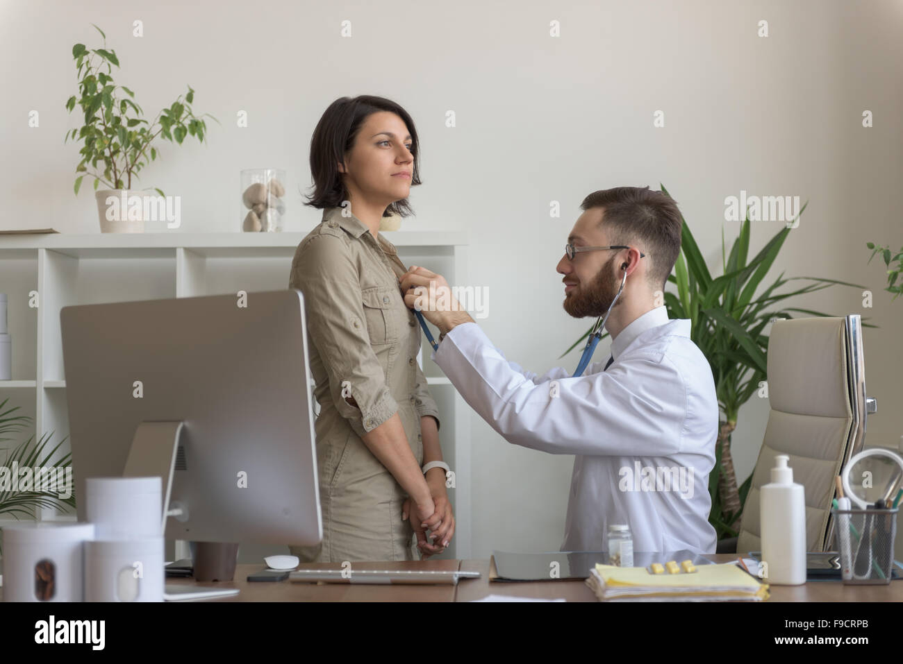 At doctor office. Doctor listening patient breathing Stock Photo - Alamy