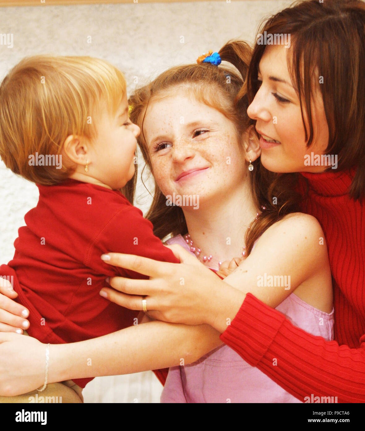 Mother And Her Two Daughters Caressing Stock Photo - Alamy