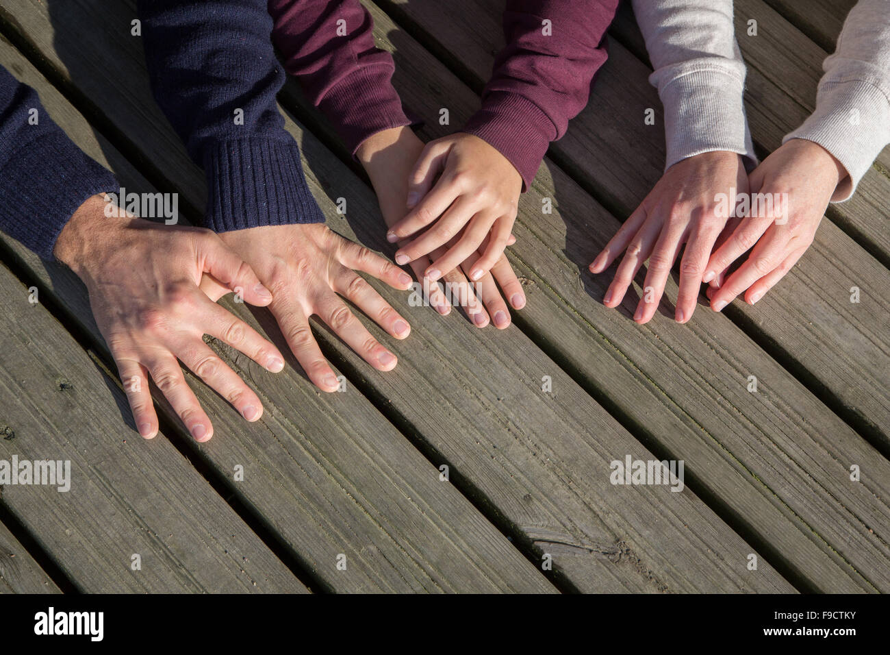 A family holding hands Stock Photo - Alamy