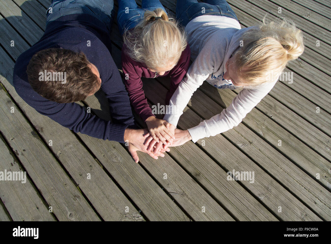 A family holding hands Stock Photo - Alamy