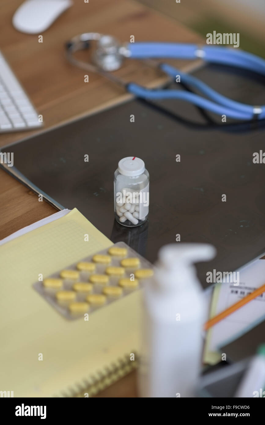 At doctor office. Pills, x-ray, record and other stuff on table Stock ...