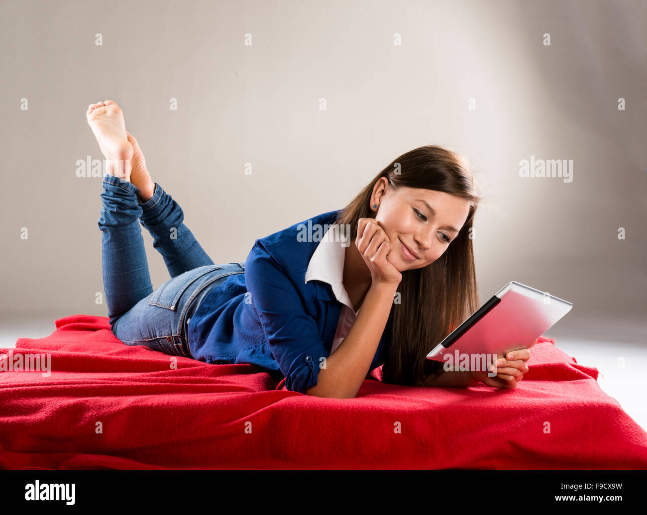 Beautiful girl with tablet is isolated in her room Stock Photo - Alamy