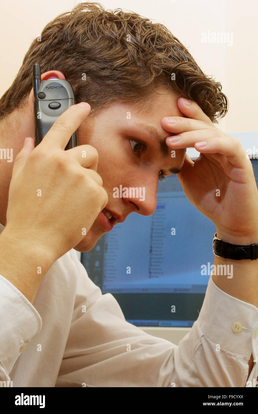 Young Man Phoning in Office Stock Photo - Alamy