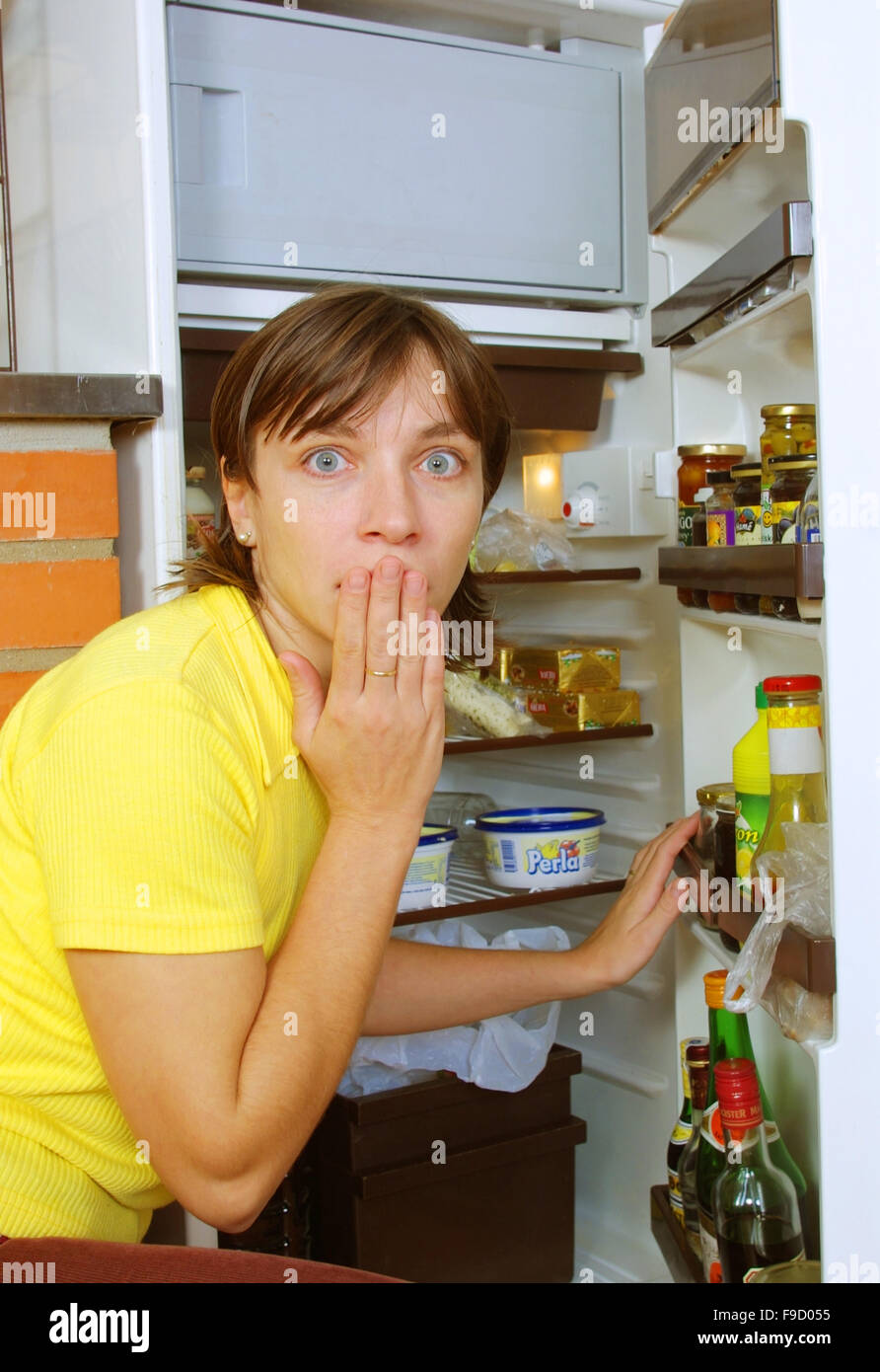 Woman Is Afraid in front of The Fridge Stock Photo - Alamy