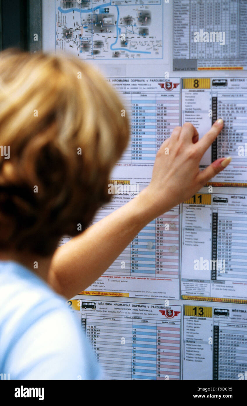 Girl Pointing on Time-Table Stock Photo - Alamy