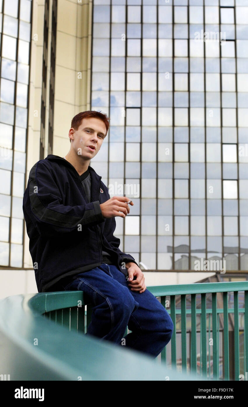 Boy Sitting on Railing And Smoking Stock Photo - Alamy