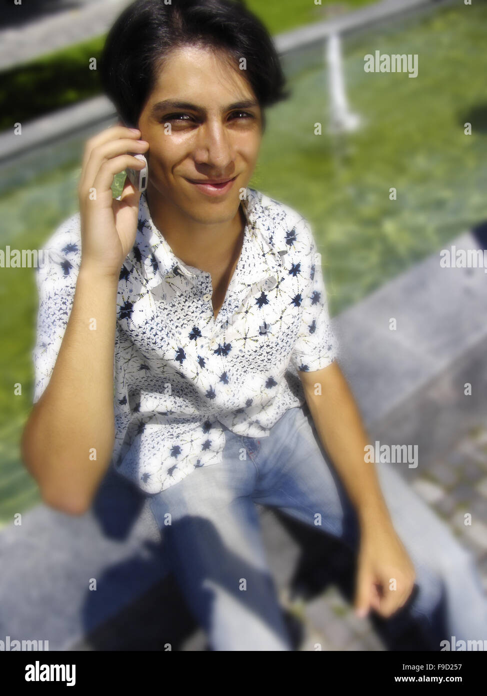 Young man phoning Stock Photo - Alamy