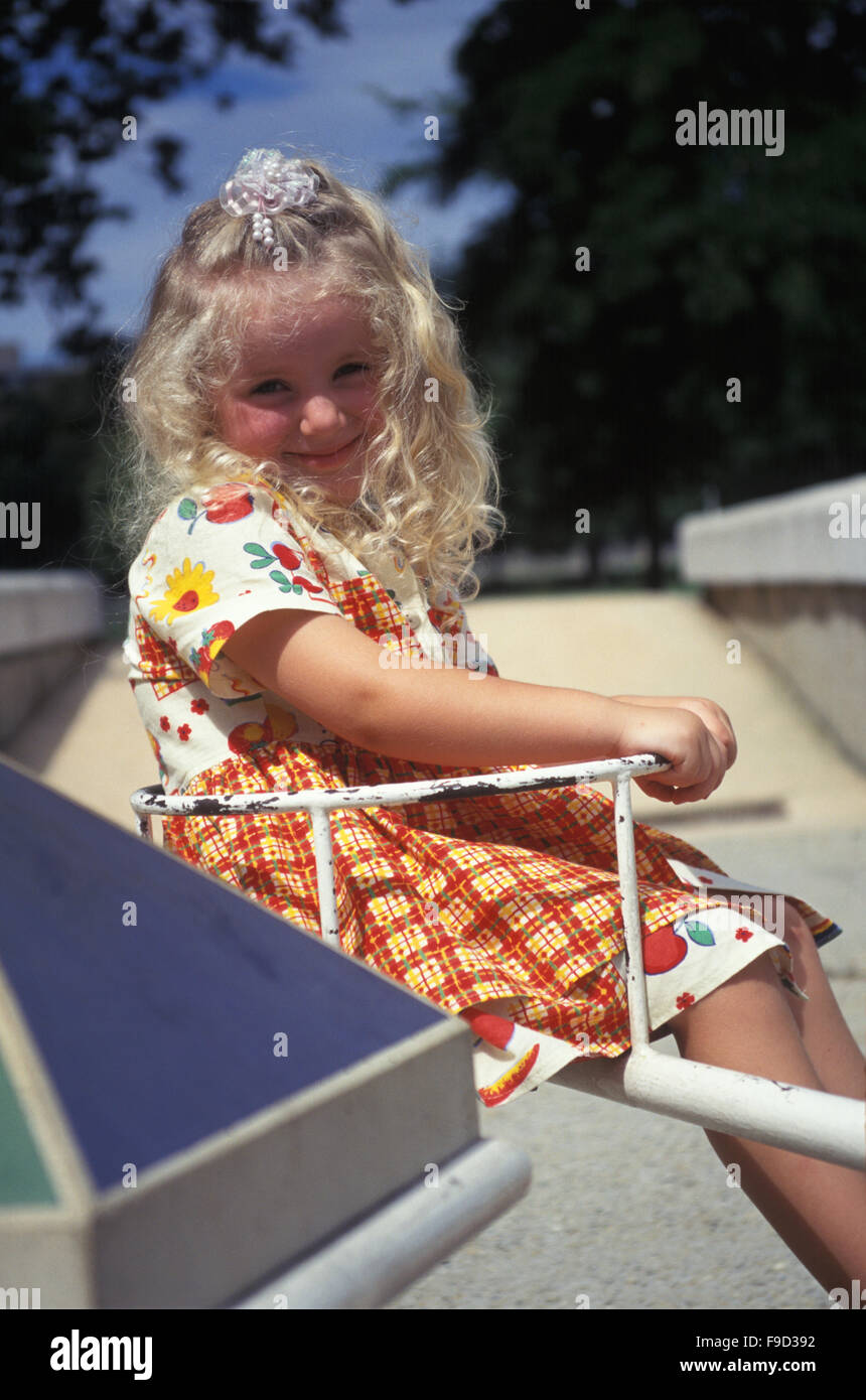 Little girl on roundabout Stock Photo - Alamy