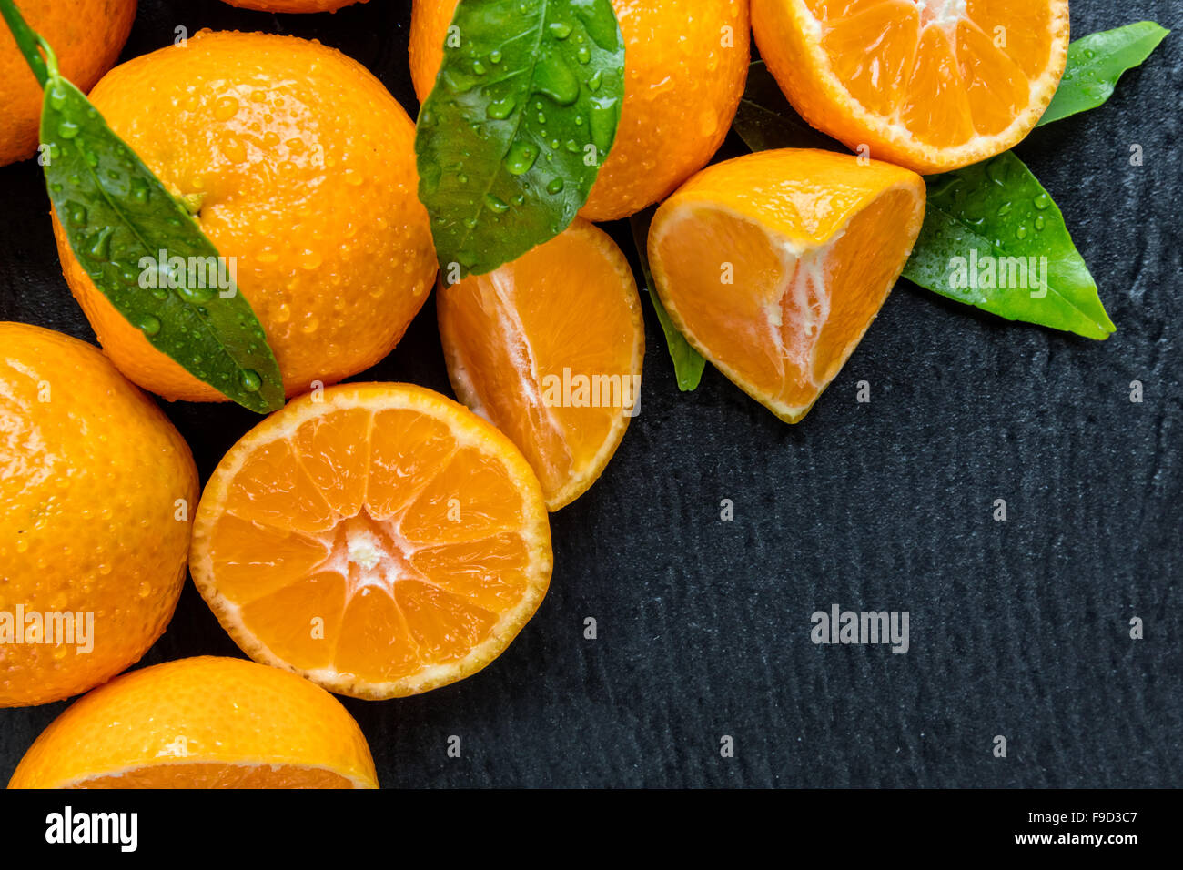 Fresh mandarin on black stone Stock Photo - Alamy
