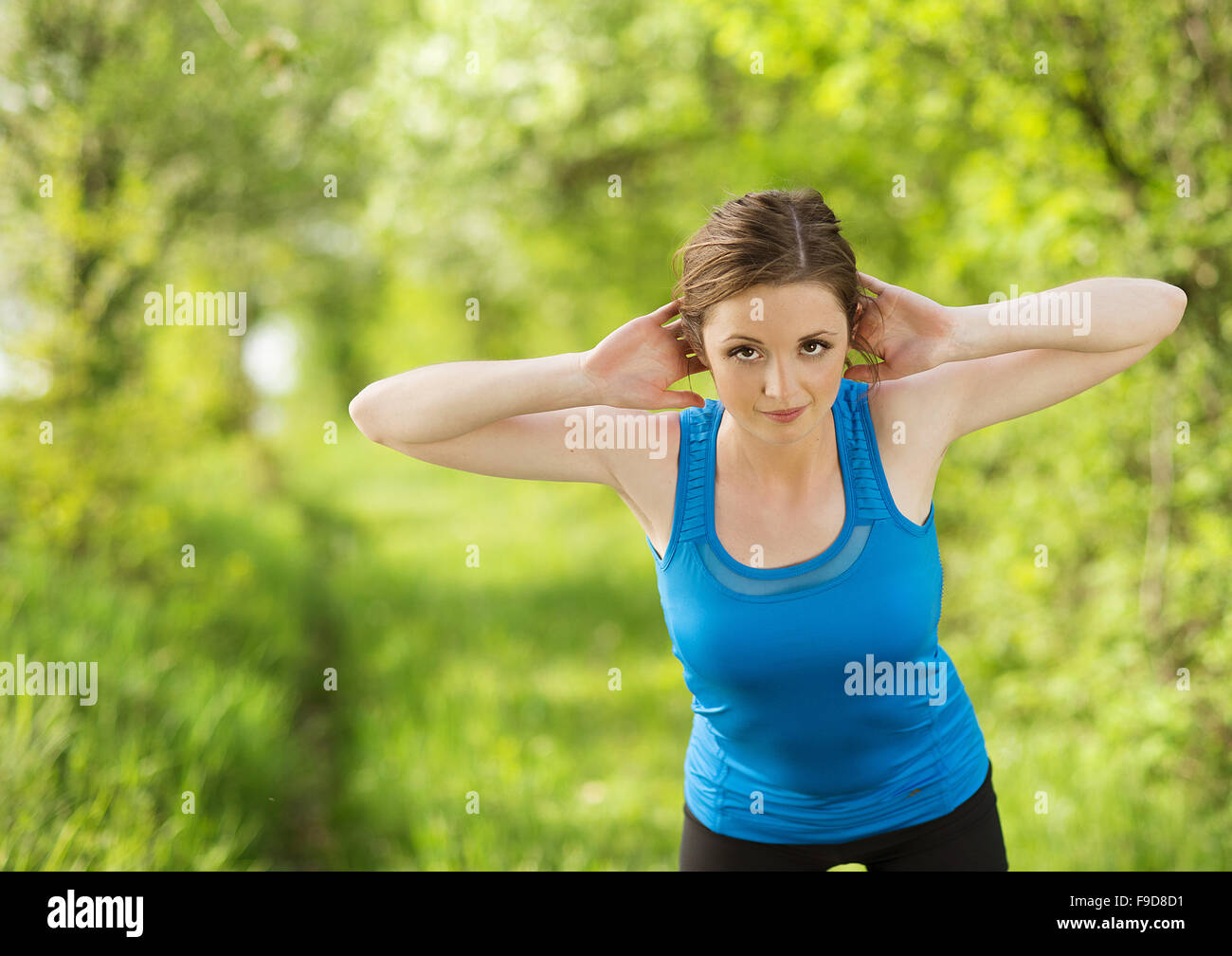 Pretty young athlete is doing exercise in nature Stock Photo - Alamy