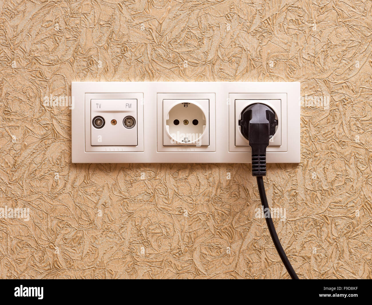 Two electric outlets with plug and sockets for television and radio ...