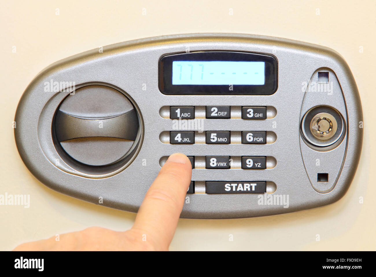 Man finger press button on electronic home safe Stock Photo - Alamy