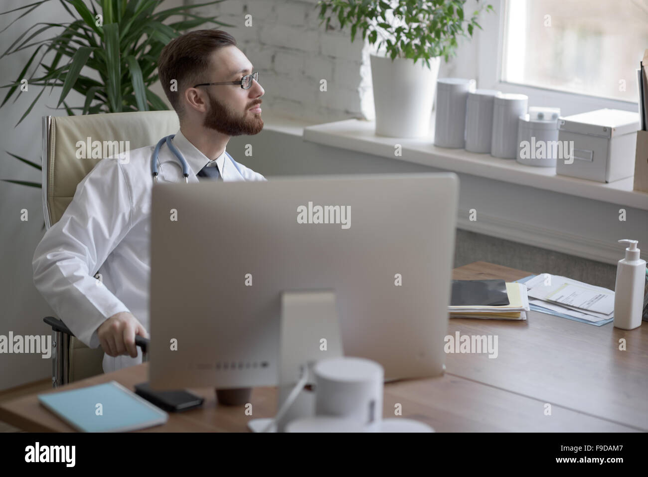 Doctor sitting relaxed in chair hi-res stock photography and images - Alamy