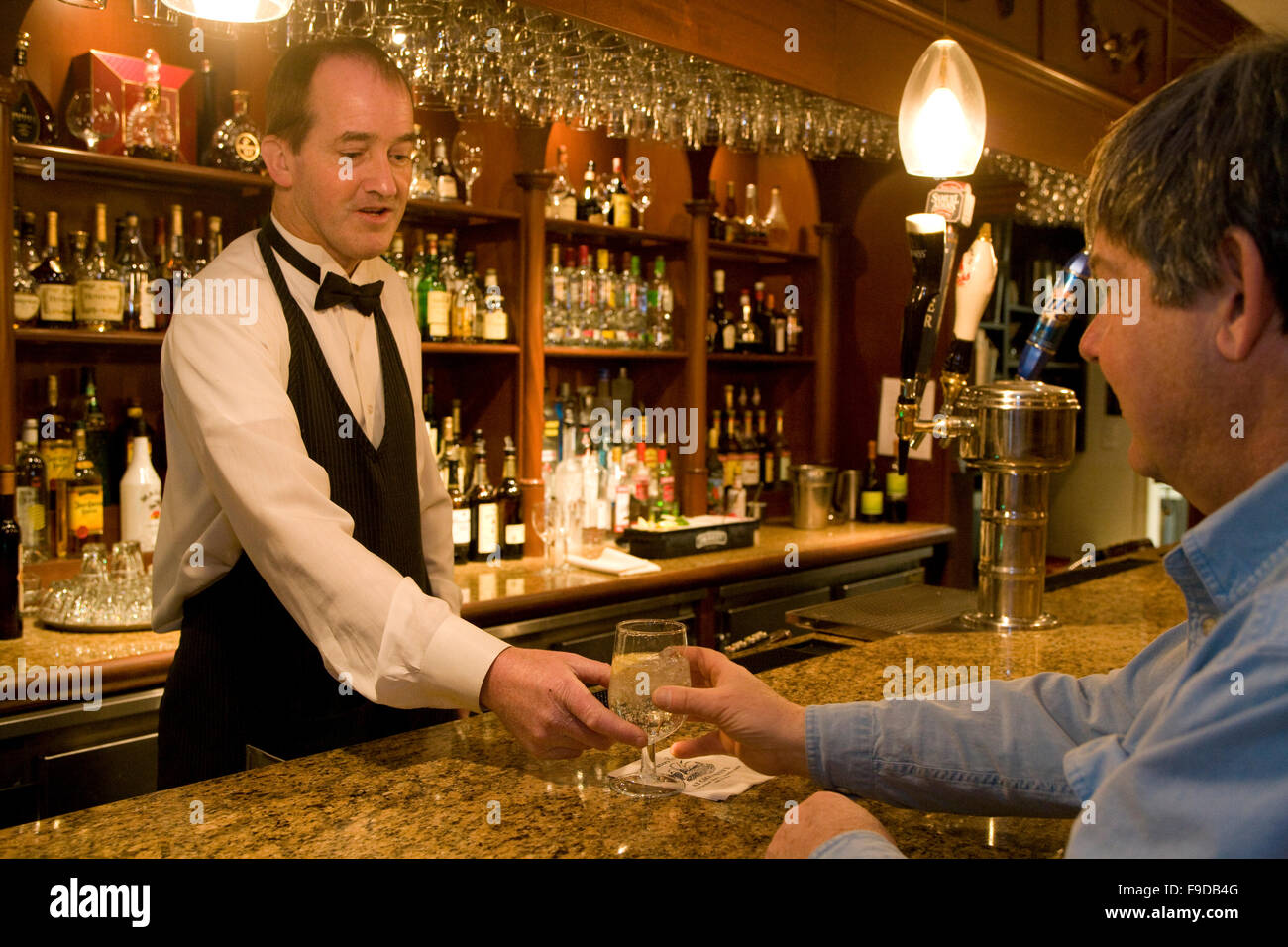 Barman serving drinks Stock Photo - Alamy