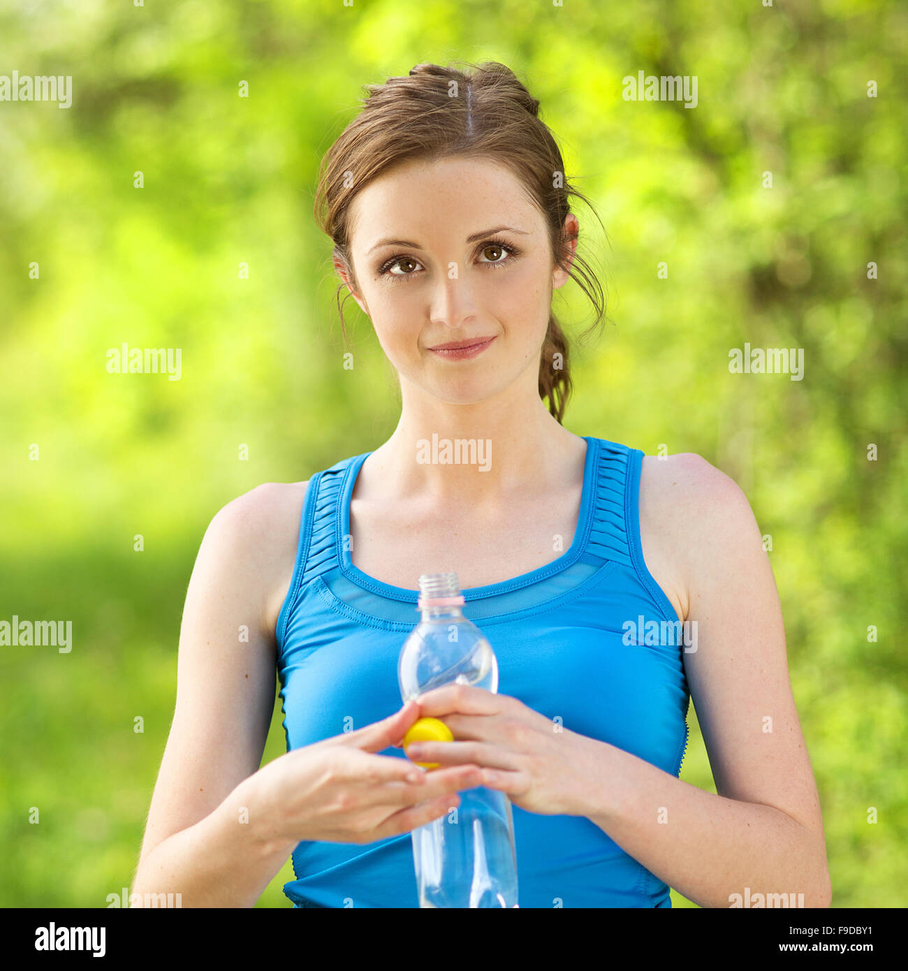 Athlete refreshing with a bottle of water during the outdoor exercise ...