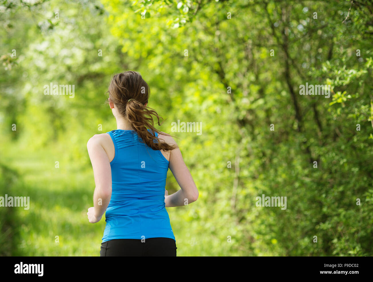 Pretty young girl runner in the forest Stock Photo - Alamy