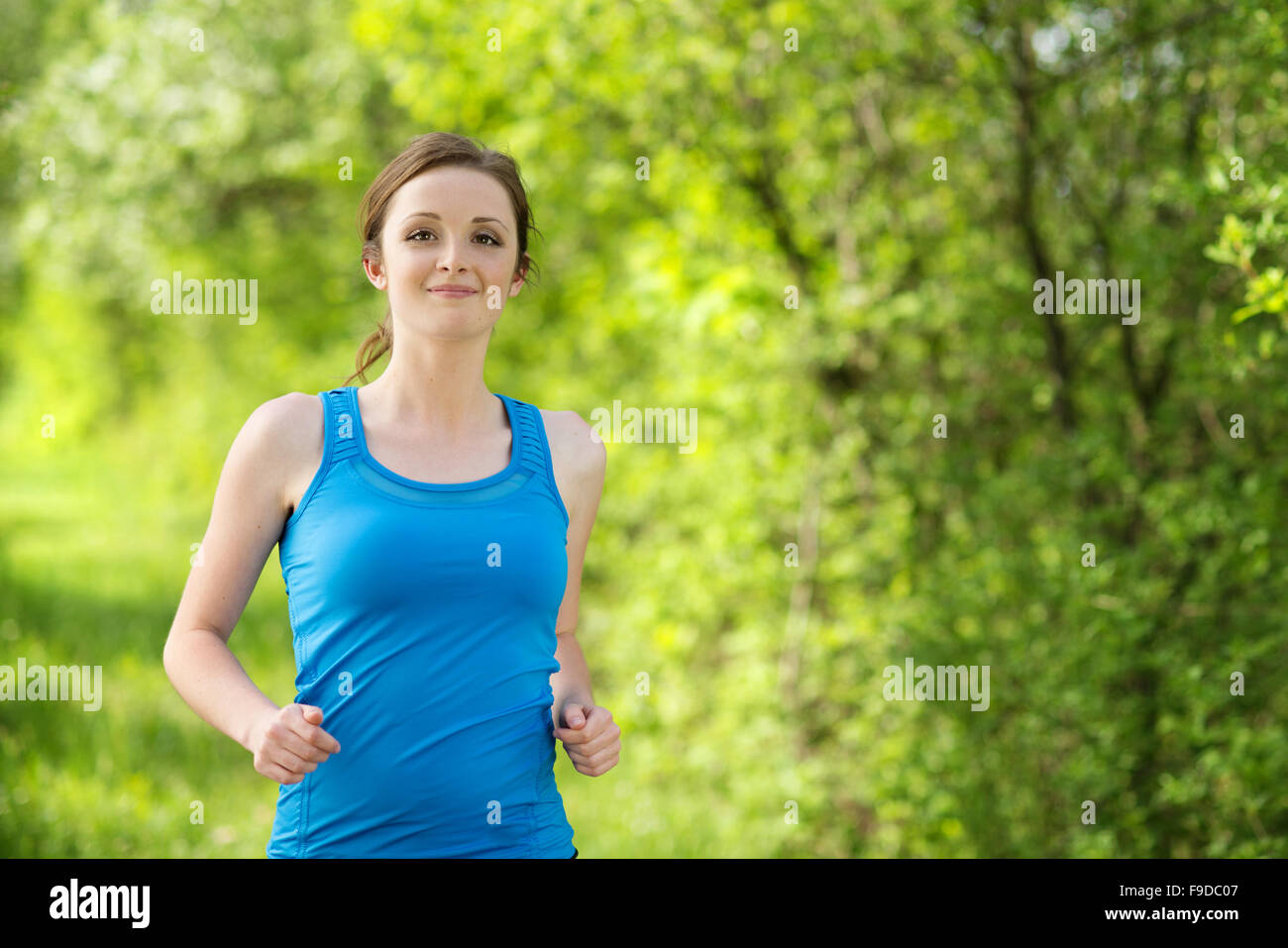 Pretty young girl runner in the forest Stock Photo - Alamy