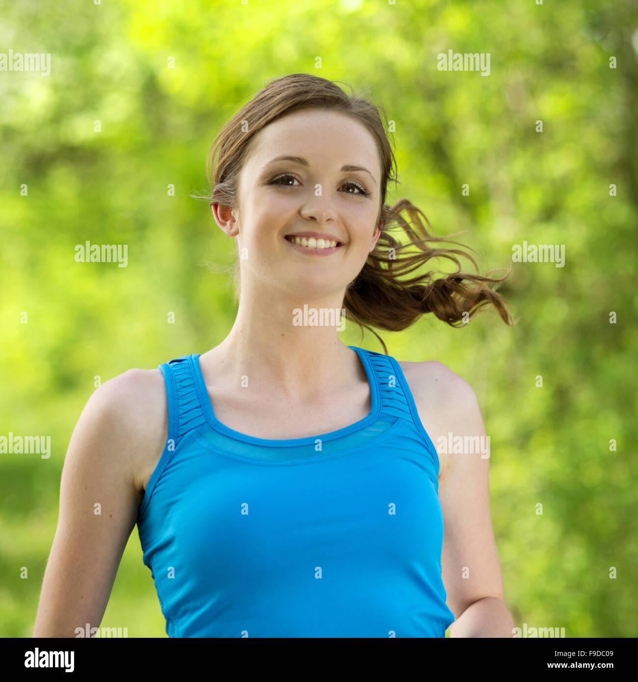Pretty young girl runner in the forest Stock Photo - Alamy