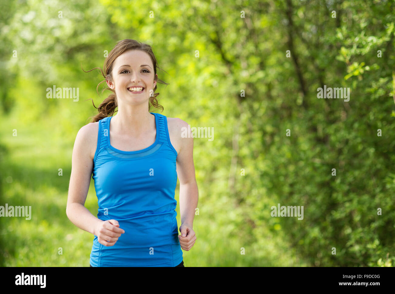 Pretty young girl runner in the forest Stock Photo - Alamy