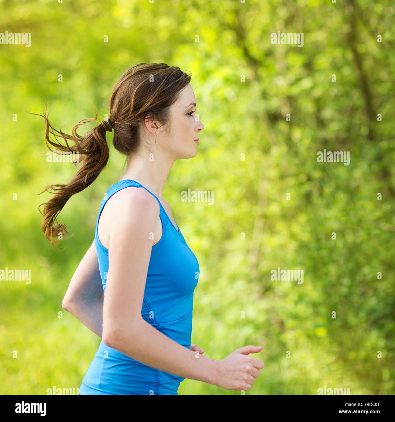 Pretty young girl runner in the forest Stock Photo - Alamy