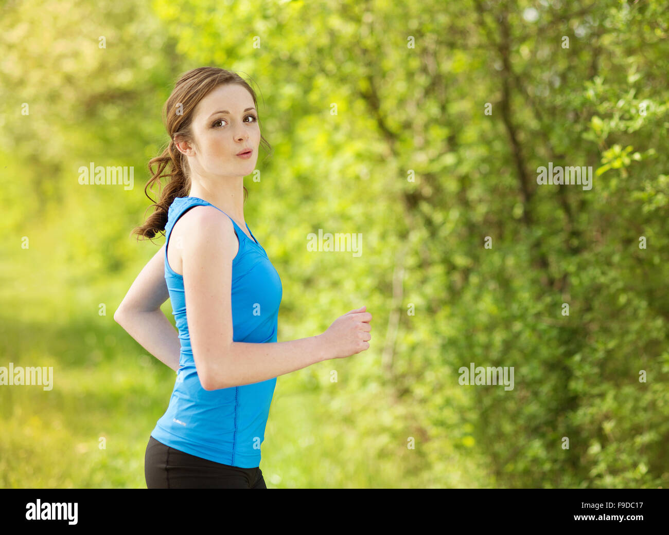 Pretty young girl runner in the forest Stock Photo - Alamy
