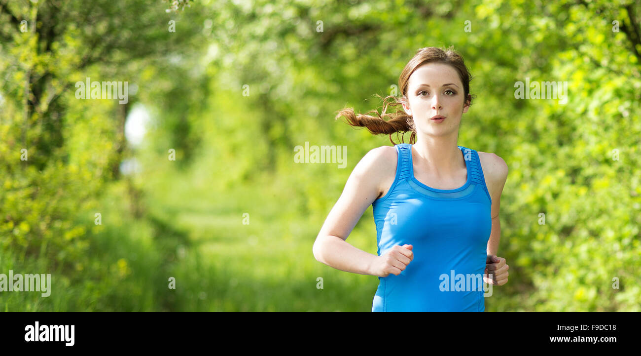 Pretty young girl runner in the forest Stock Photo - Alamy