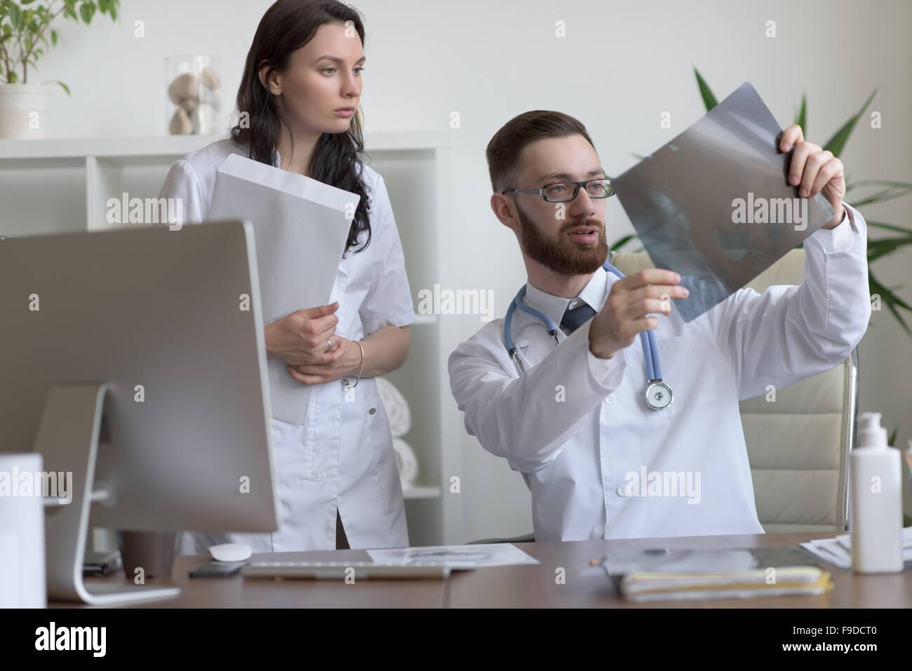 Doctors discussing intestines xray at medical office Stock Photo - Alamy