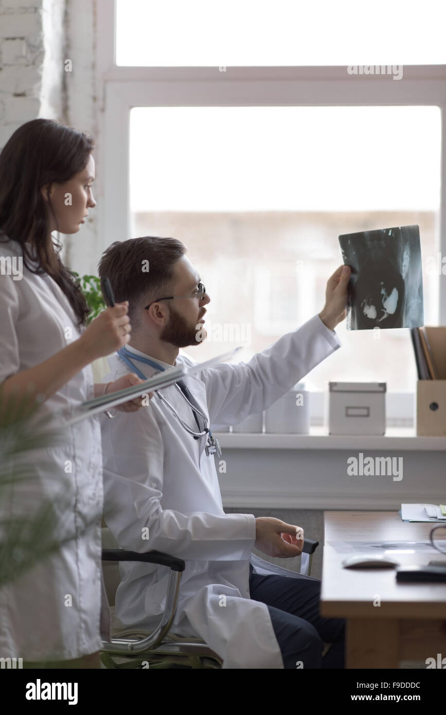 Doctors discussing intestines xray at medical office Stock Photo - Alamy
