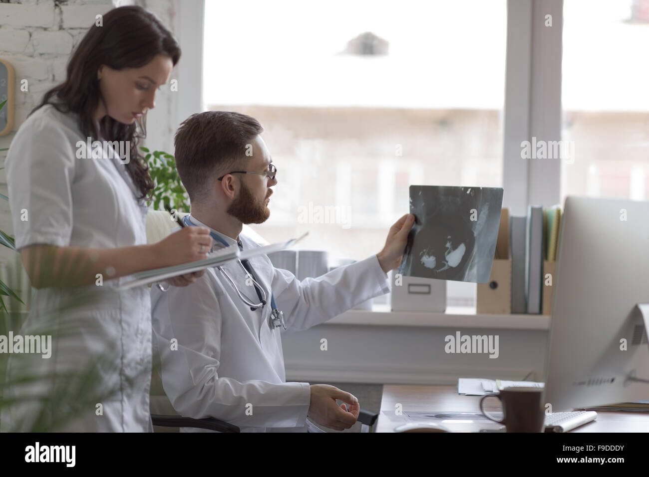 Doctors discussing intestines xray at medical office Stock Photo - Alamy