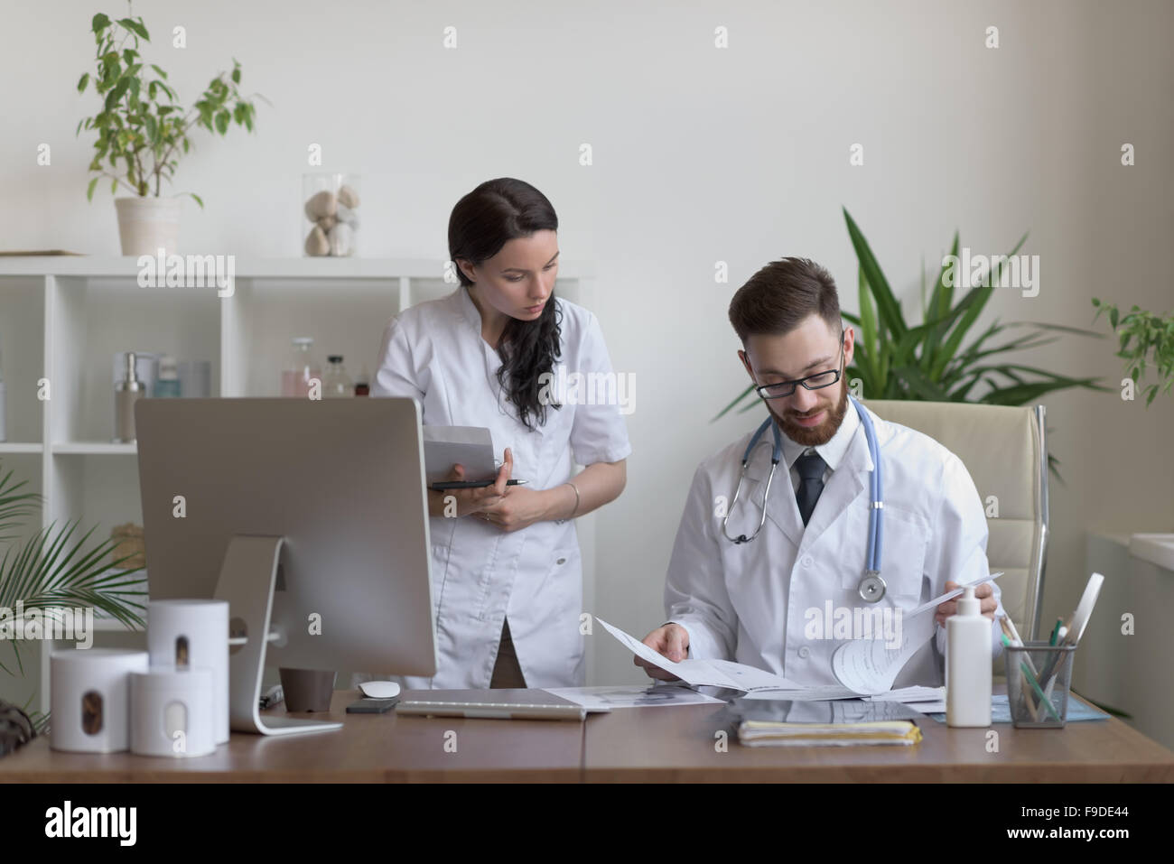Two doctors discussing test results and working together Stock Photo ...