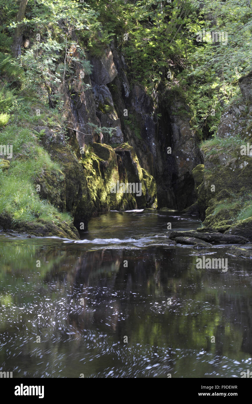 Water flowing into a sunlit gorge Stock Photo - Alamy