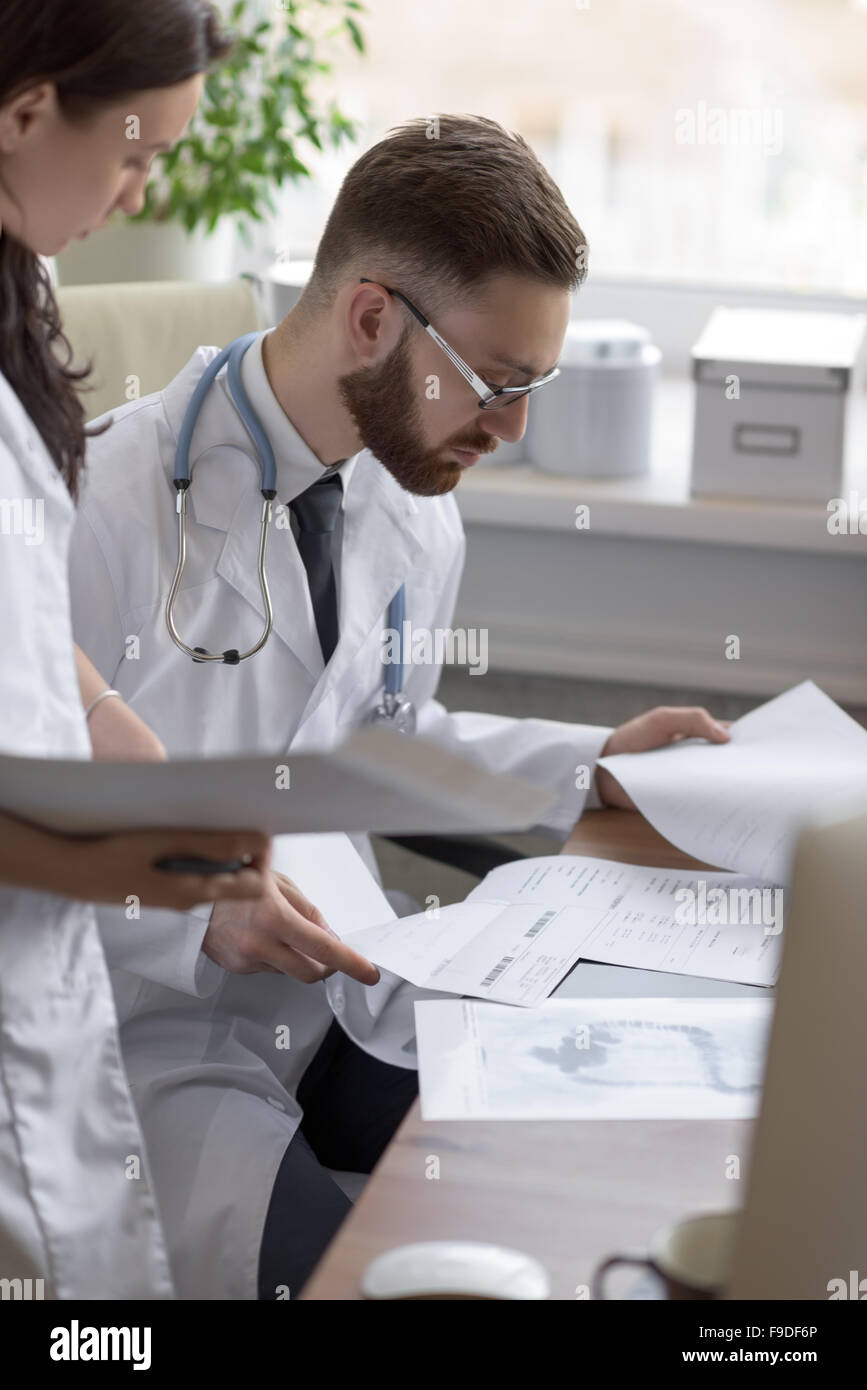 Two doctors discussing test results and working together Stock Photo ...