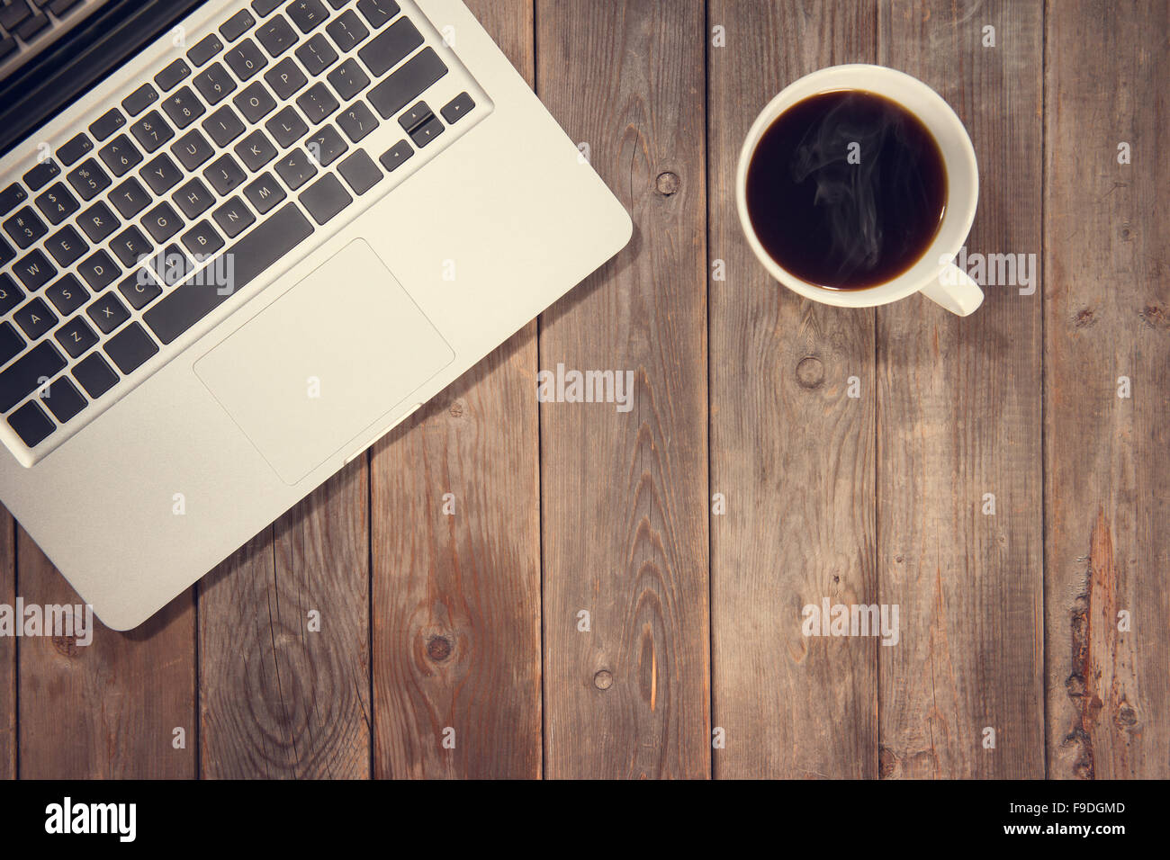 Top view workplace with laptop computer and hot coffee cup. Wooden ...