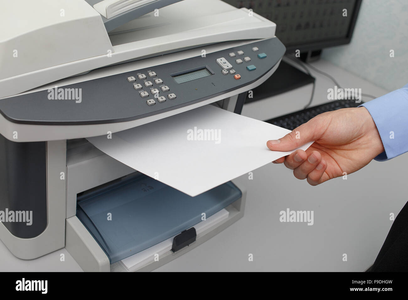 Businessman working with printer in the office Stock Photo - Alamy