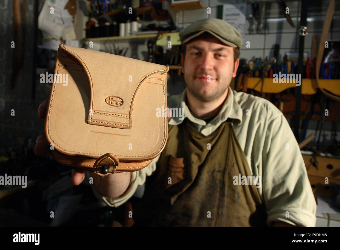 Leather Worker Showing Handmade Bag Stock Photo - Alamy