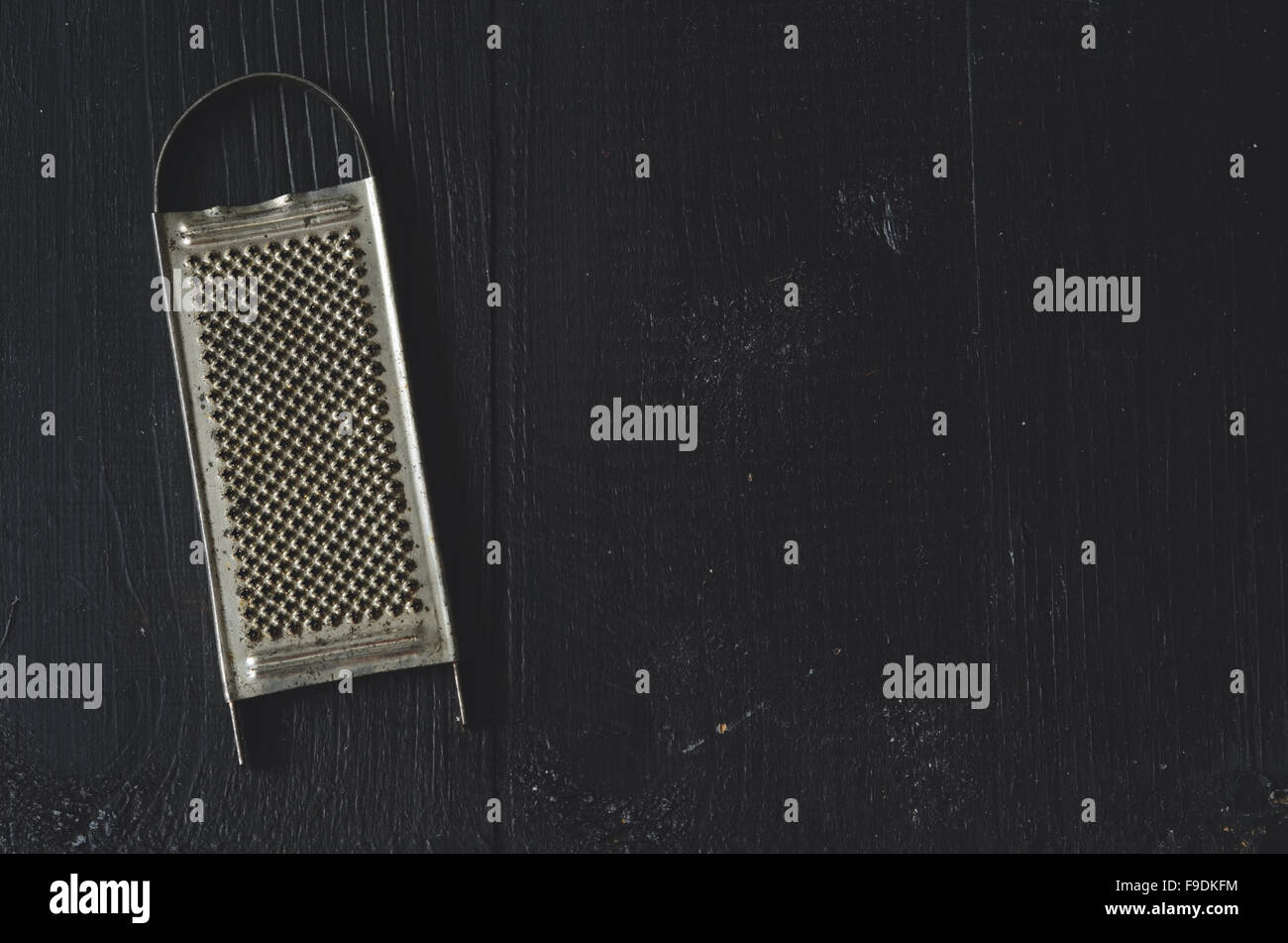 aged old rustic grater on a dark wooden table with copy space Stock ...