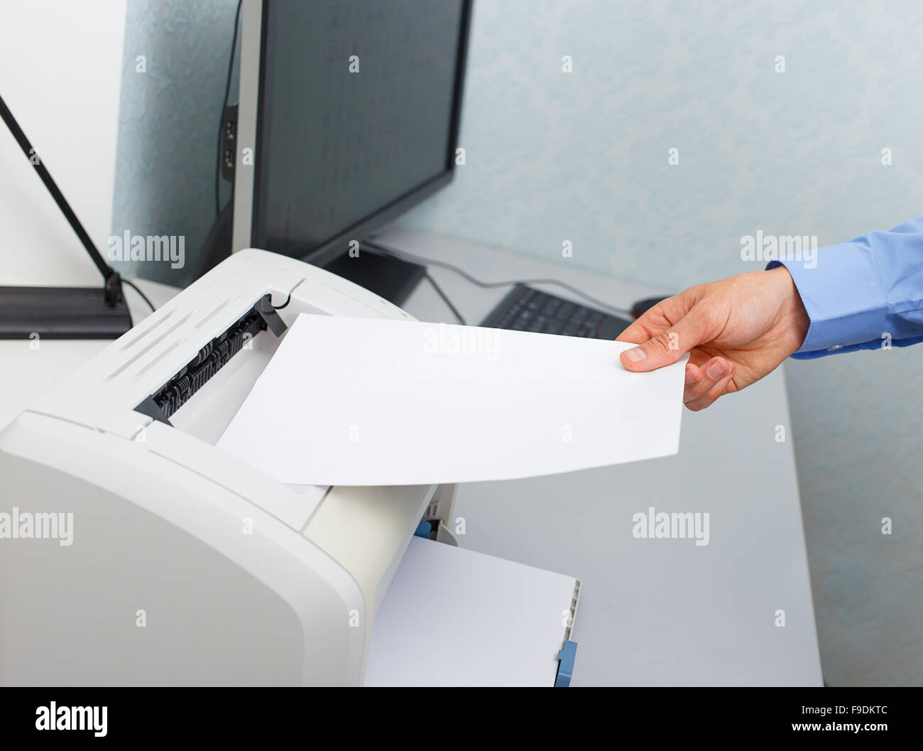 Businessman working with printer in the office Stock Photo - Alamy