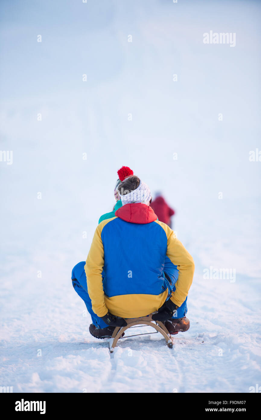Young family sledging in winter Stock Photo - Alamy
