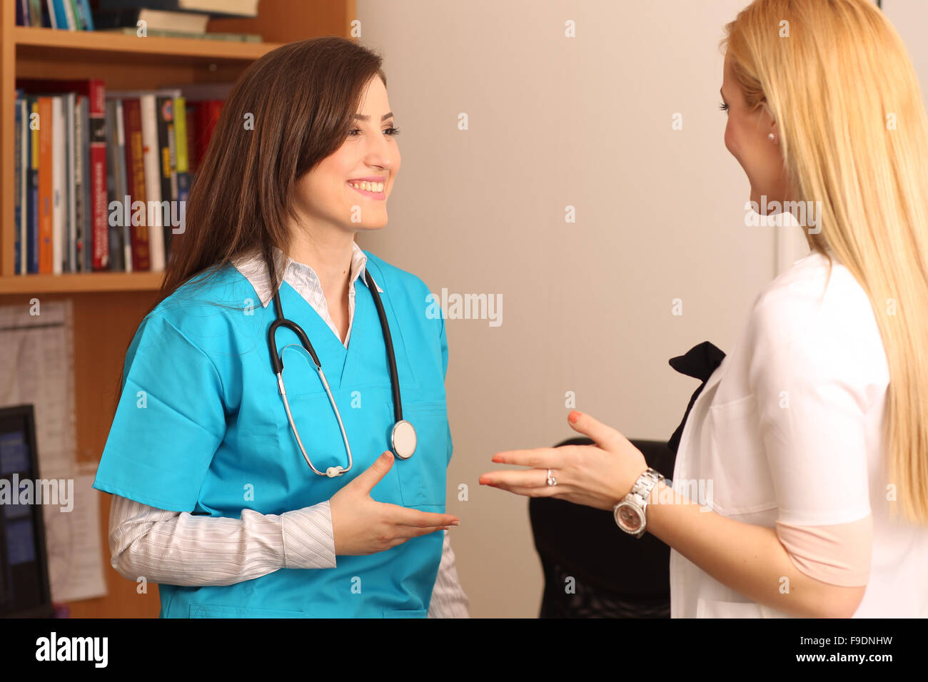 Two beautiful female doctors smiling at work Stock Photo - Alamy