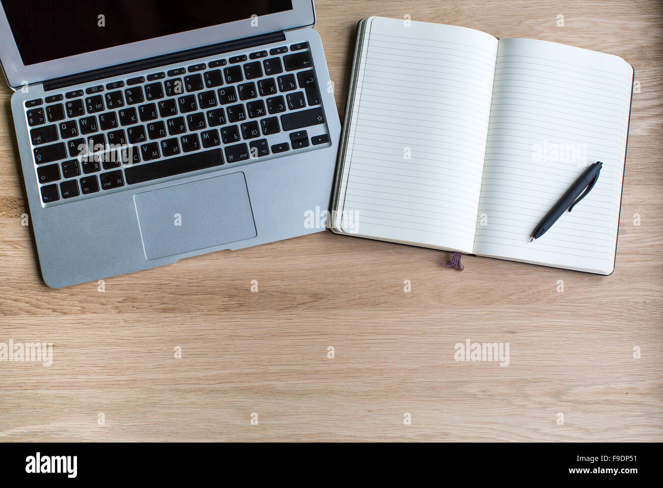 Laptop and Notepad on wooden table Stock Photo - Alamy