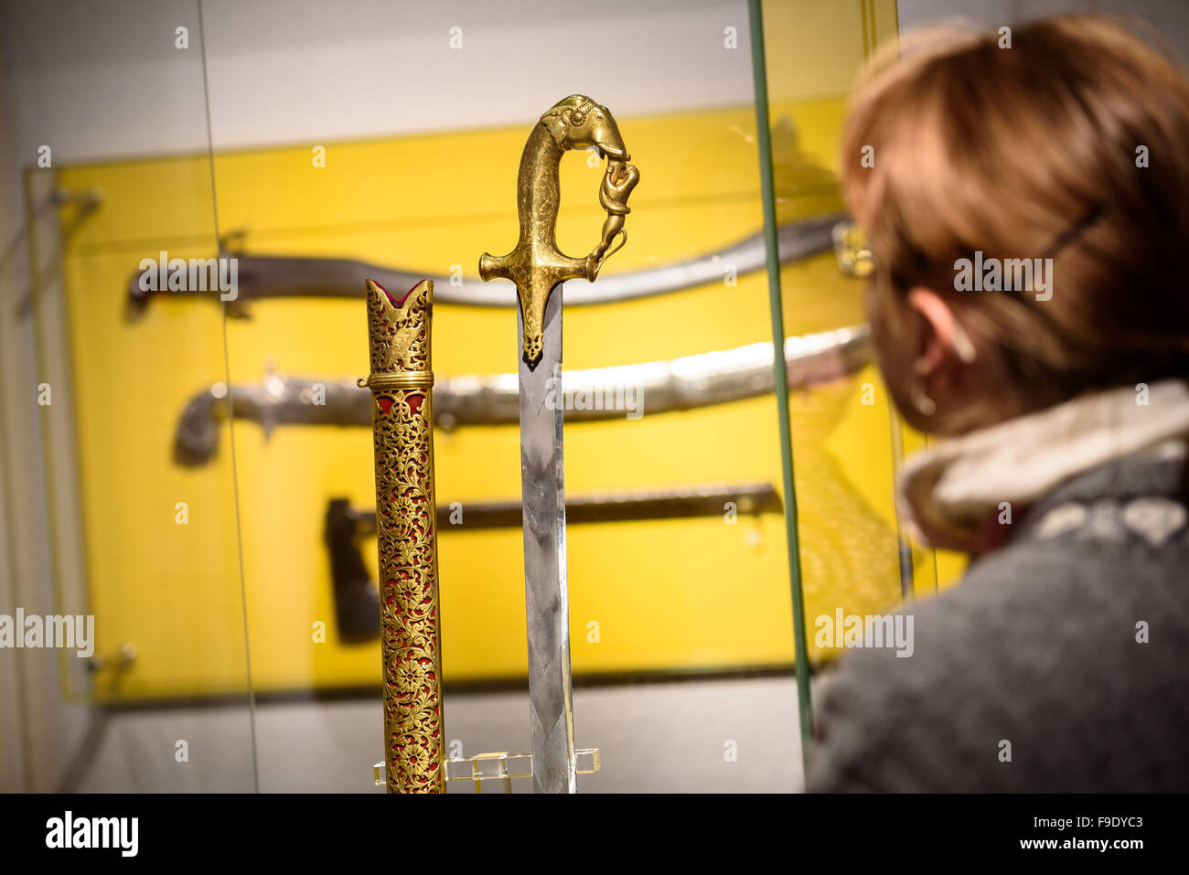 A visitor looks at a blade made of various angles of damask steel from ...