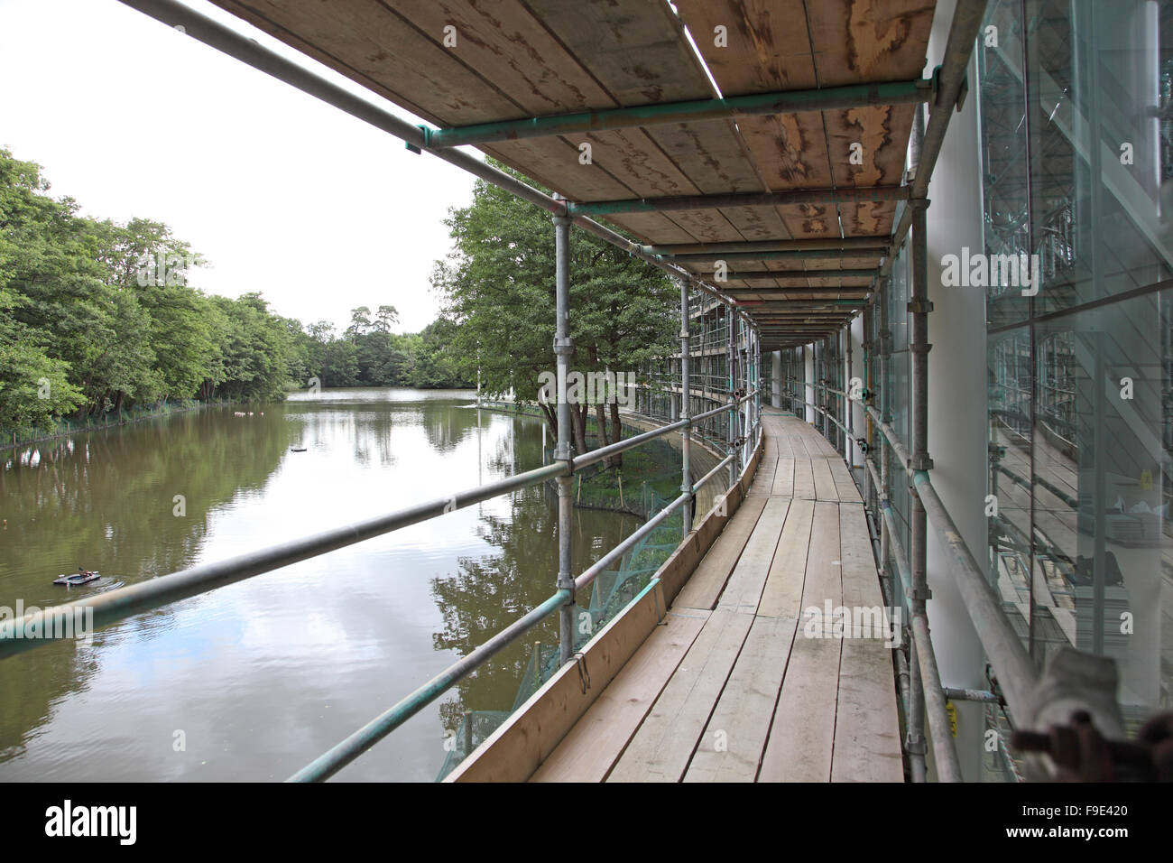 Ground level of a curved scaffolding structure surrounding an office ...