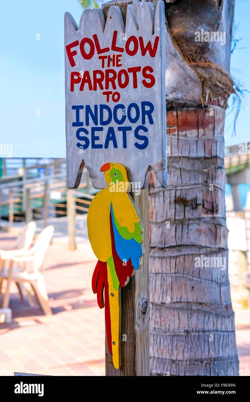 Follow the Parrots to indoor seating sign outside a beachf-ront ...