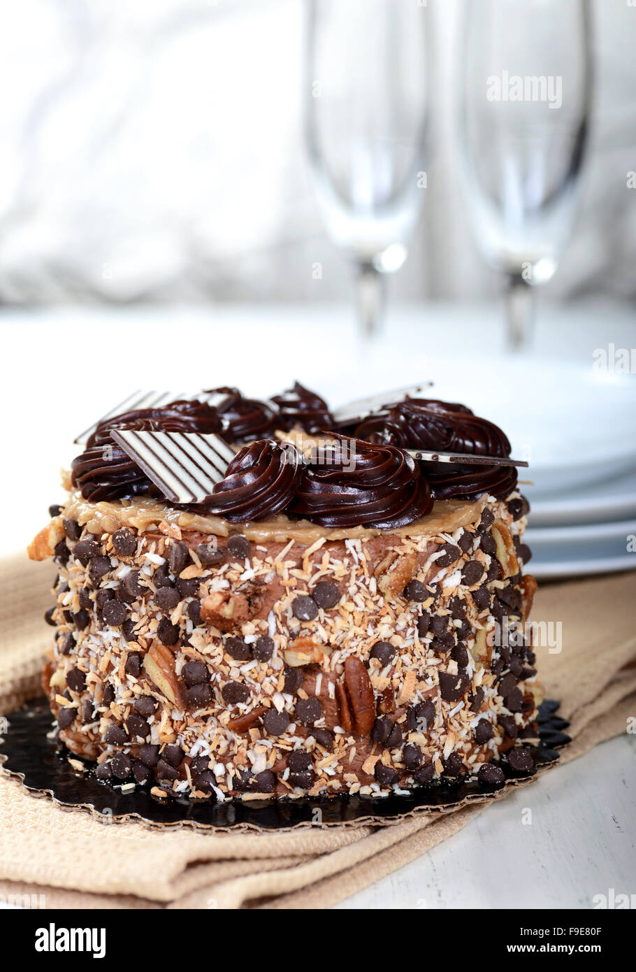 Whole German Chocolate Cake with plates and Champagne glasses Stock ...